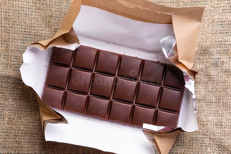 Close-up Chocolate in Opened Wrapper is Lying on Burlap. Stock Image ...