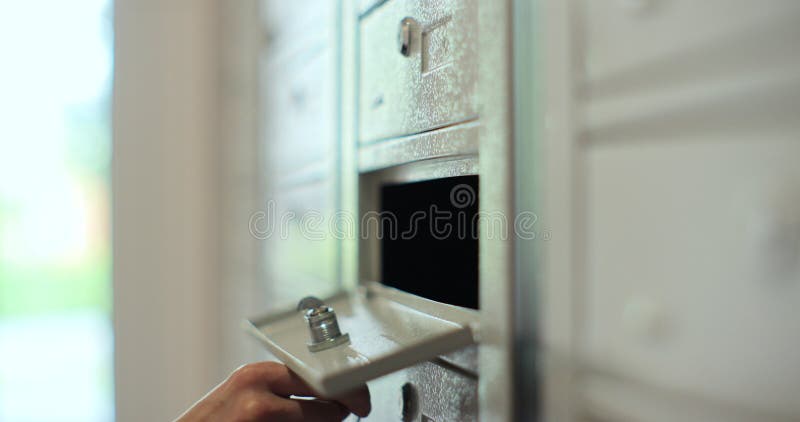 Close-up Woman Checking Her Mail at an Apartment Complex Mailbox. Mail ...
