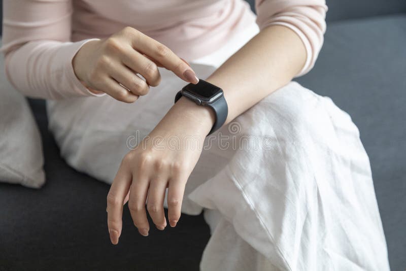 Close Up of Woman Checking Smart Watch Sitting on Sofa. Stock Photo ...
