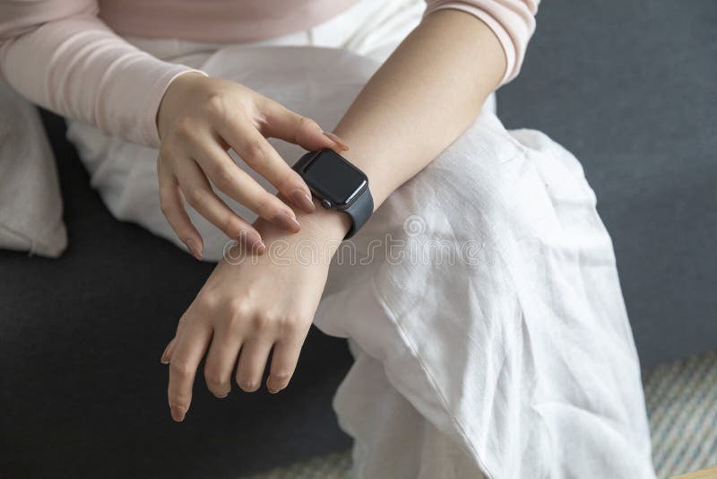 Close Up of Woman Checking Smart Watch Sitting on Sofa. Stock Photo ...