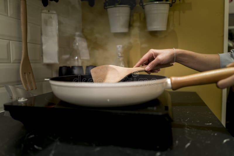 Close Up Woman Cooking with Pan in Kitchen at Home Stock Image - Image ...
