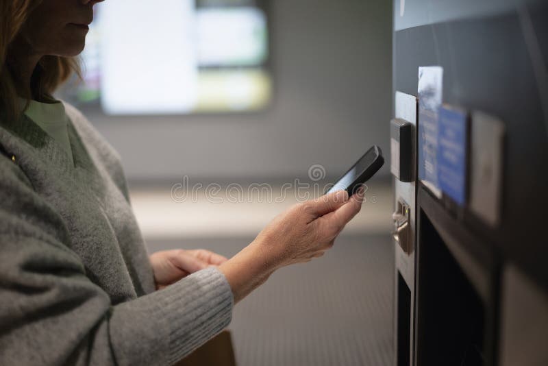 Close-up of a Woman Driver Standing in Front of a Parking Machine and ...