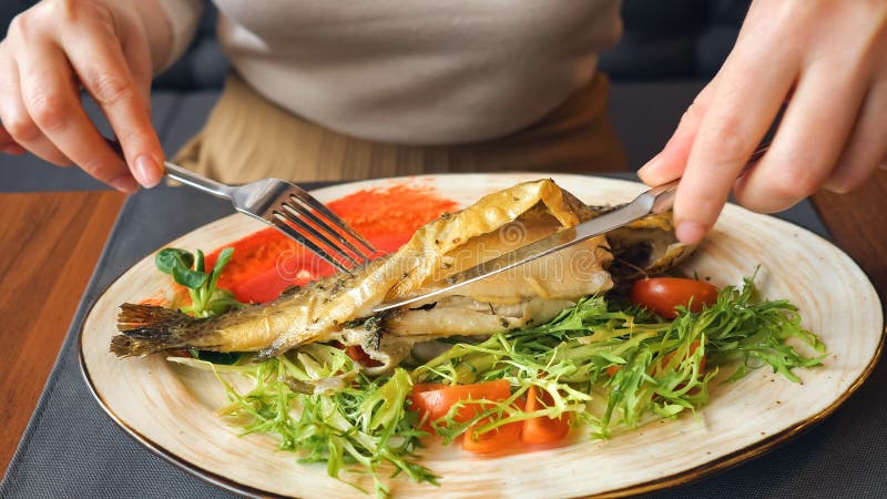 Close Up of Woman Eating Fish Steak with Knife and Fork Stock Image ...