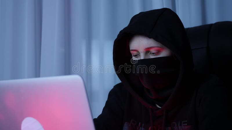Close Up of Woman Face in Black Mask and Hood Breaking Password on ...