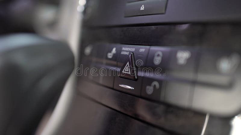 Close-up of Woman Fingers Pressing Emergency Button on Car Dashboard ...