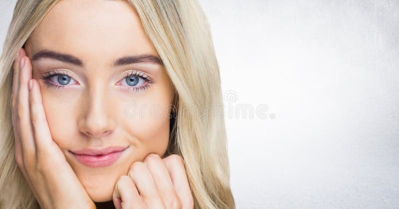 Close Up of Woman with Hand on Face Against White Wall Stock Photo ...