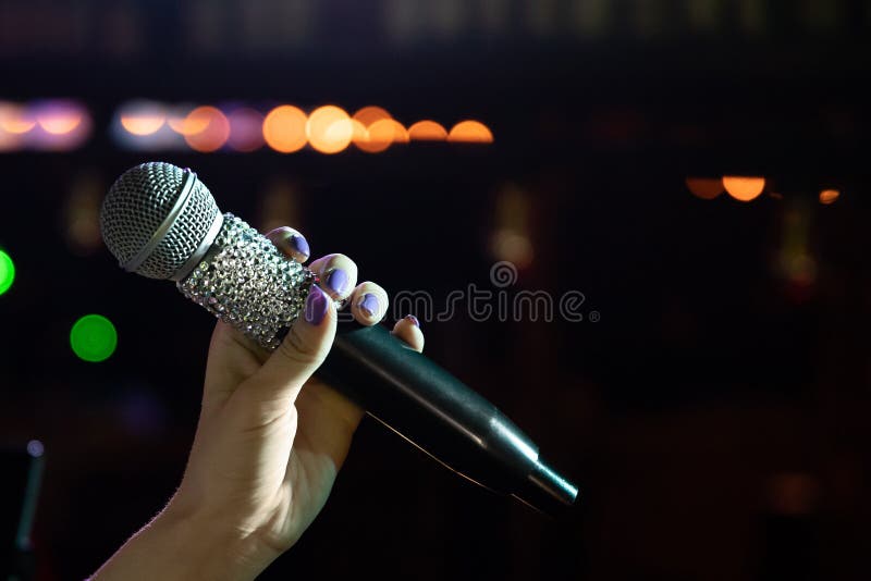 Close-up of Woman Hand Holding Microphone on Stage, Copy Space Stock ...