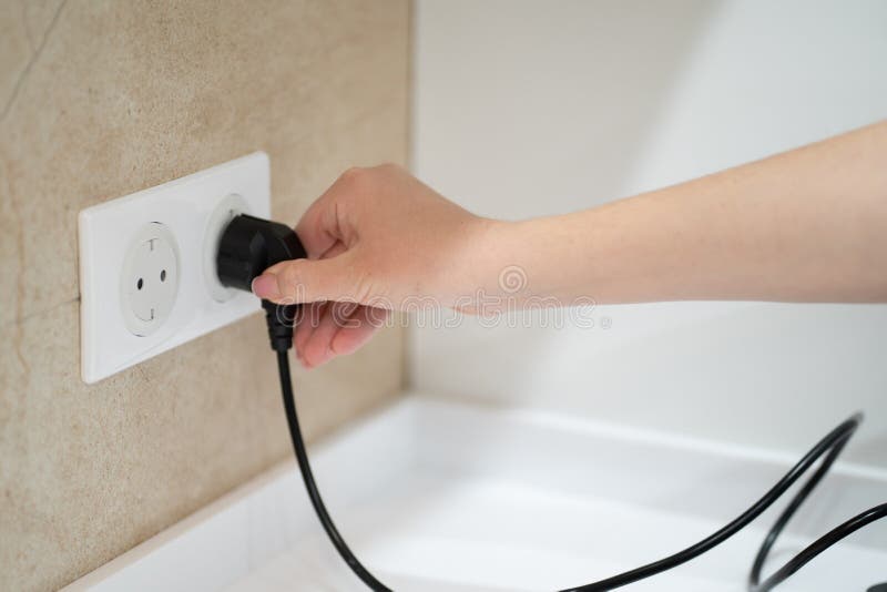 Close Up Woman Hand Insert or Pull Out Elecrticity Plug in Outlet on ...