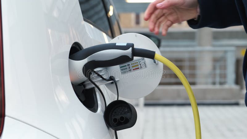 Close Up Woman Hand Inserts Power Cable from Electric Car. Stock ...