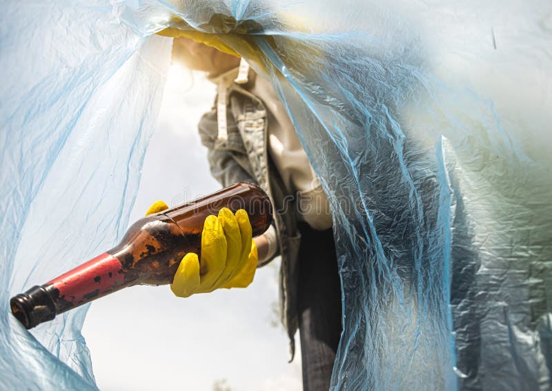 Close-up of a Hand Throwing Garbage into a Plastic Bag. View from ...