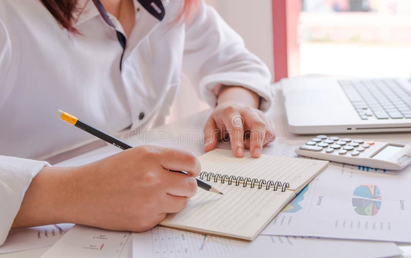 Close Up Woman Hand Using Calculator and Writing Make Note with Stock ...