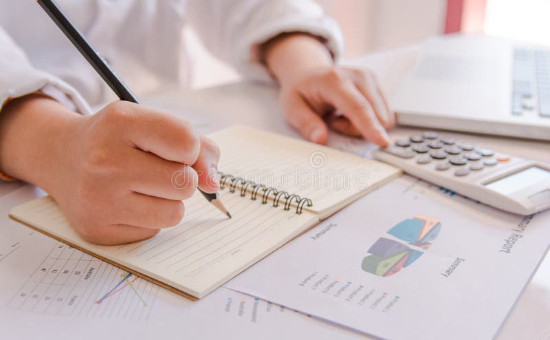 Close Up Woman Hand Using Calculator and Writing Make Note with ...