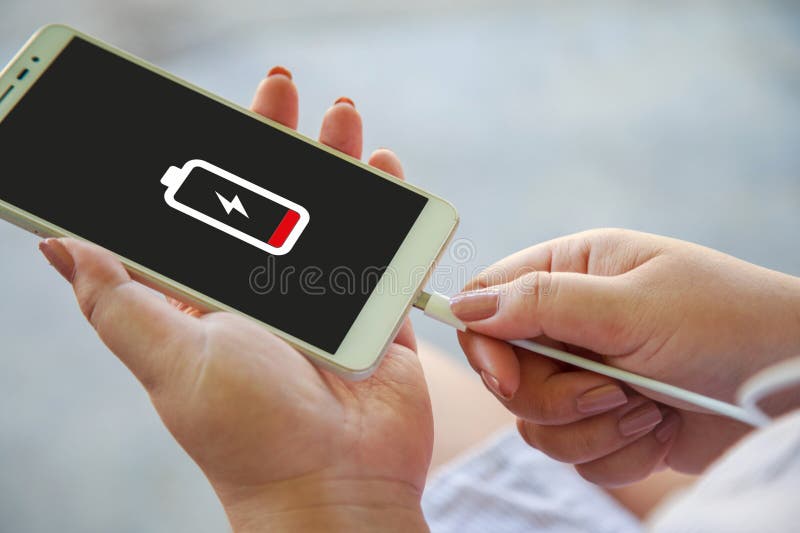 Close Up a Woman Hands Charging Her Smart Phone with Charging Icon ...