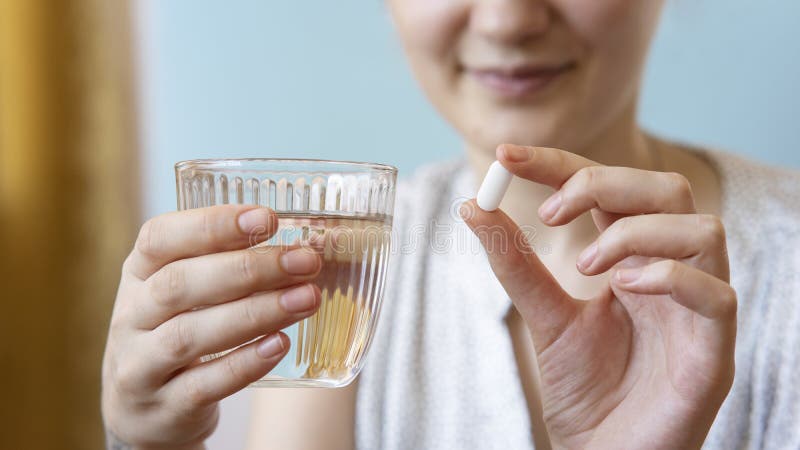 Close Up Woman Holding Pill In Hand With Water Female Going To Take