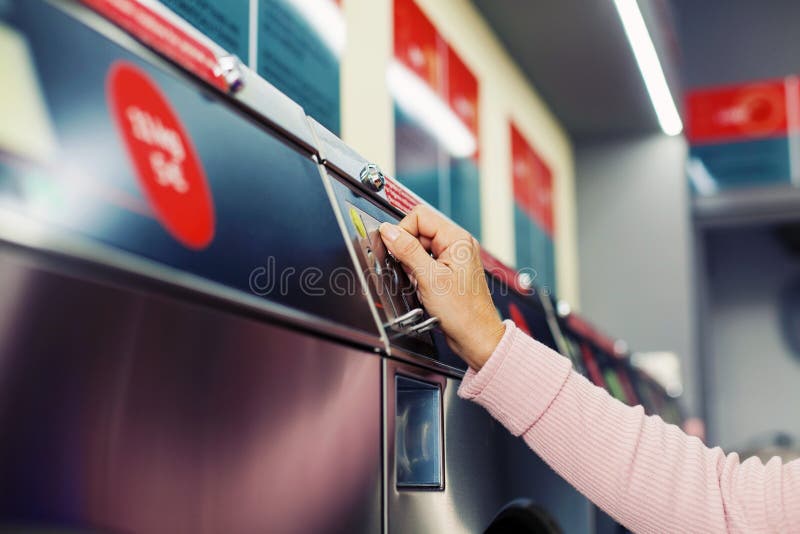 Woman Inserting Coin in Self Service Washing Machine Close-up Stock ...