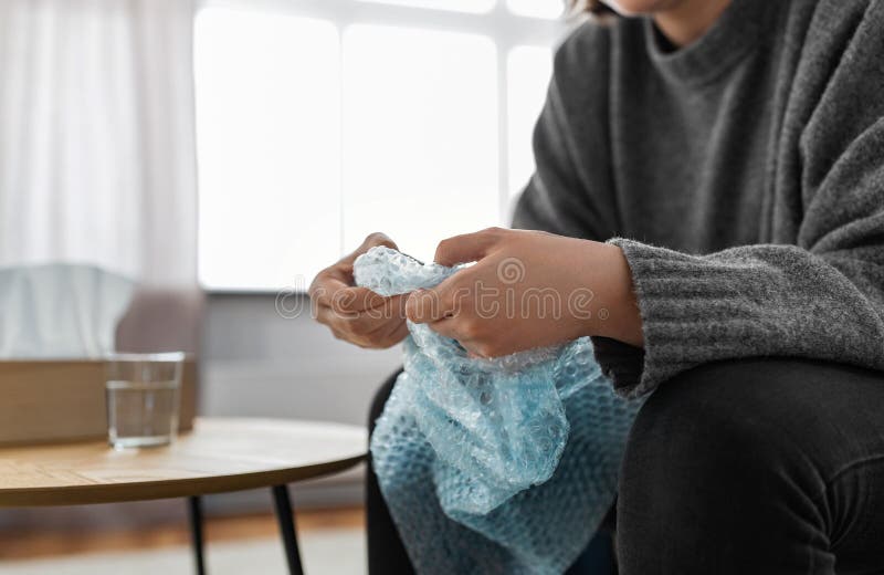 Close Up of Woman Popping Bubble Wrap at Home Stock Image - Image of ...