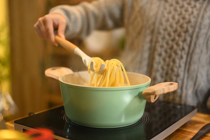 Close Up of Woman Preparing Spaghetti in a Cozy Kitchen Stock Photo ...
