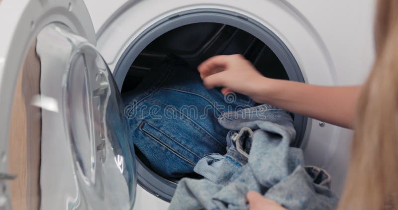 Close-up of Woman S Hands Pulling Clothes Out of Laundry, Empties ...