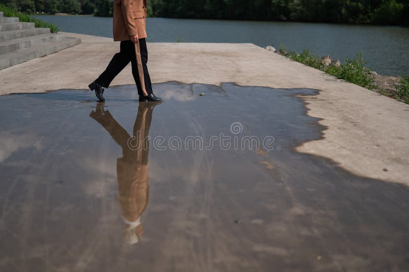Close-up of a Woman& X27;s Legs Walking on a Large Puddle. Stock Photo ...