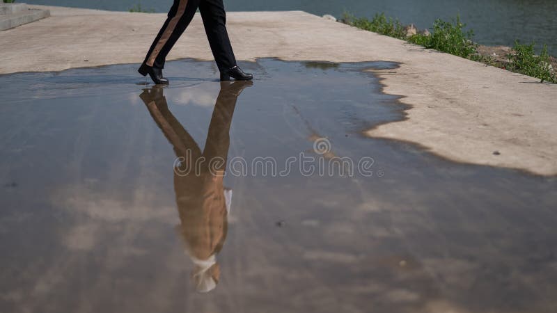 Close-up of a Woman& X27;s Legs Walking on a Large Puddle. Stock Image ...