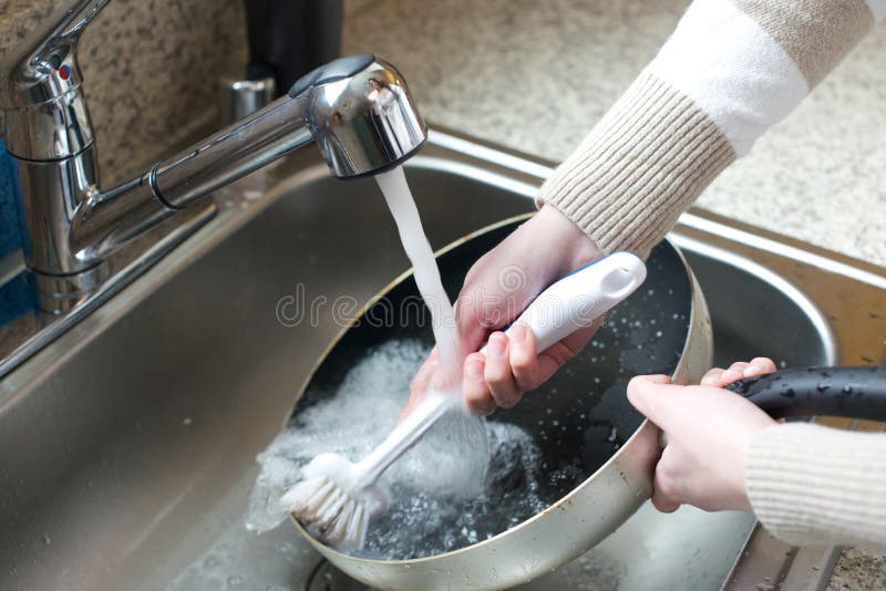 Close Up of Woman Scrubbing Pan Stock Photo - Image of dishware, chore ...