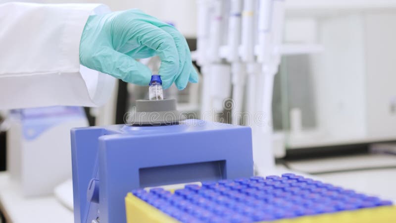 Close Up of a Woman Shaking Samples Using a Vortex Mixer before HPLC ...