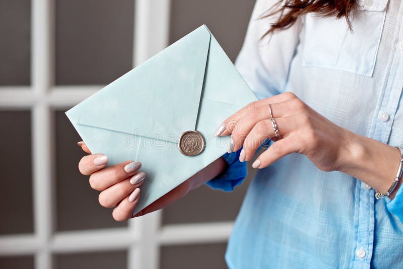 Close-up of a Woman with a Slim Body Holding a Blue Rectangular ...