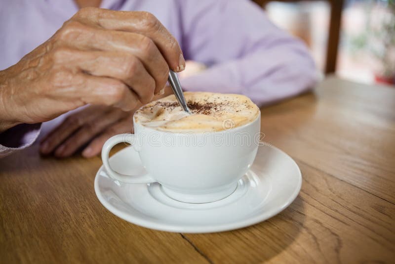 Close Up of Woman Stirring Coffee while Sitting at Table Stock Image ...