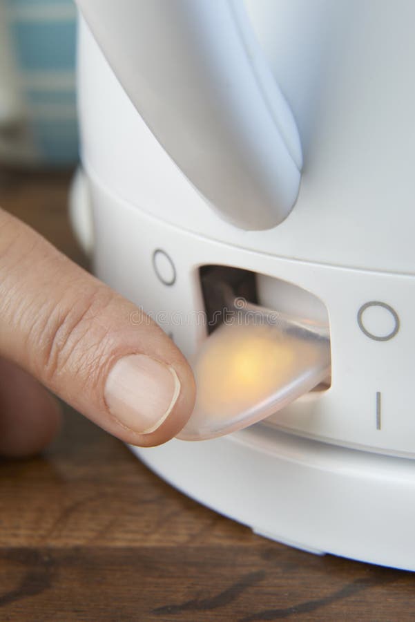 Close Up of Woman Turning on Power Switch of Kettle Stock Photo - Image ...