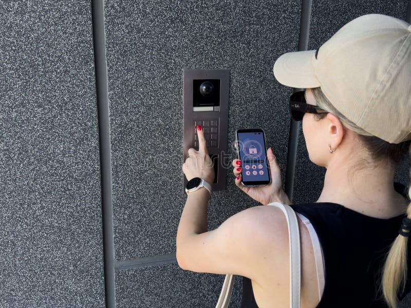 Close Up of Woman Using Intercom at Building Entrance. Stock Image ...