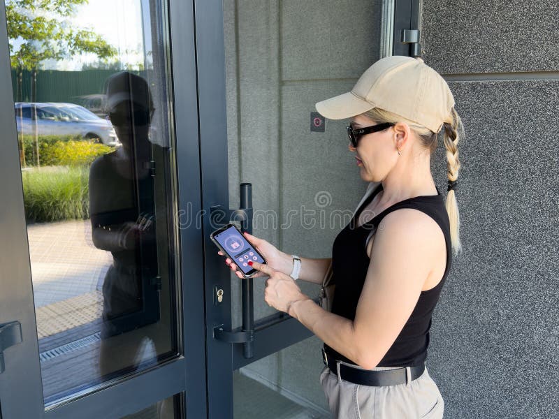 Close Up of Woman Using Intercom at Building Entrance. Stock Image ...