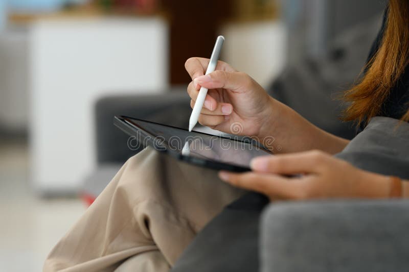 Close Up Woman Using a Stylus Pen To Write or Draw on Blank Tablet ...