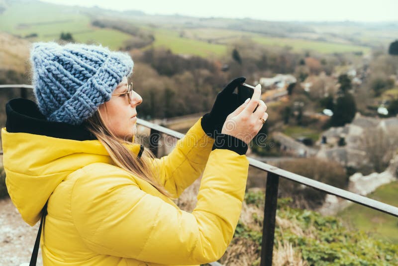Close Up Woman In Warm Bright Clothes Filming Video Or Taking Photo