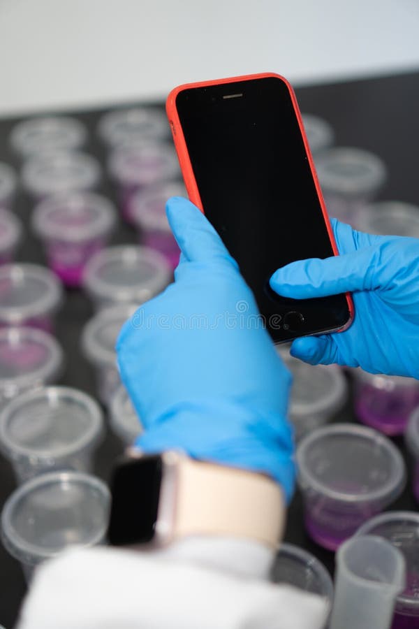 Close Up of Woman Wearing Lab Coat Using Cellphone in Laboratory Stock ...
