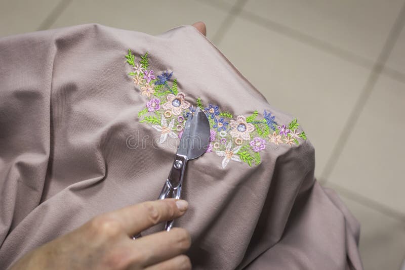 Close-up of the Woman Worker`s Hands Cut Short Loose Ends of the ...