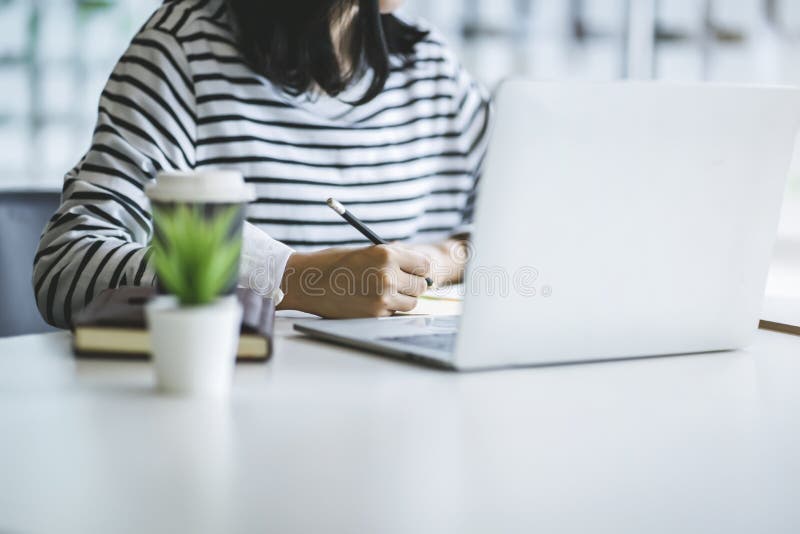 Close Up of Woman Working or Writing Something on the Book in the ...