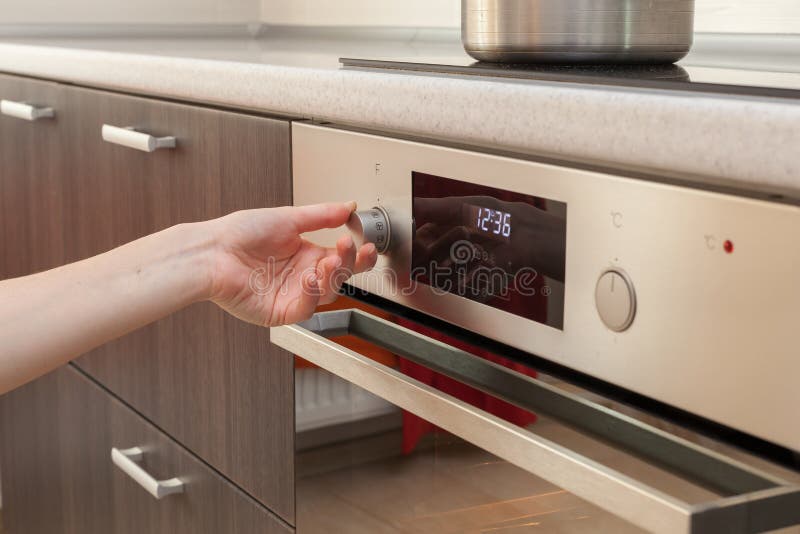 Close Up of Women Hand Setting Cooking Mode on Oven. Stock Image ...