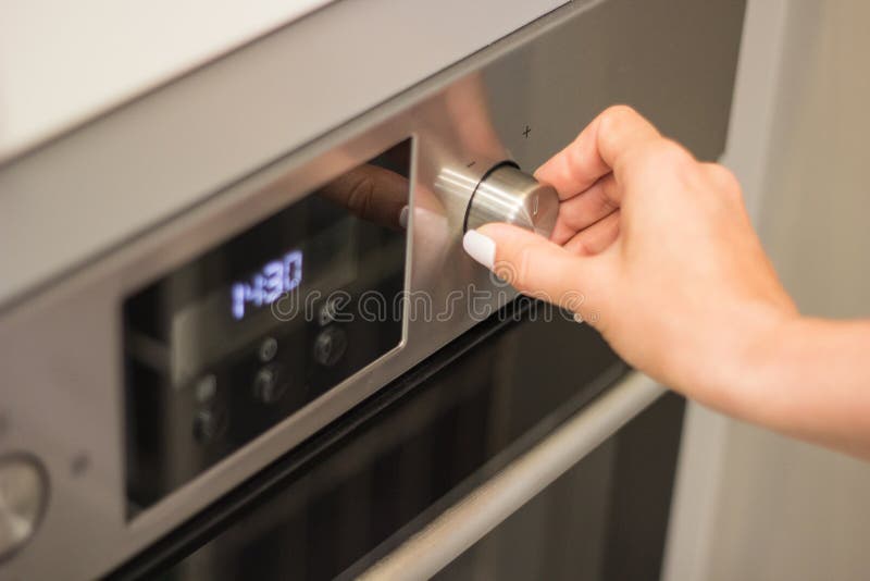 Close Up of Women Hand Setting Cooking Mode or Temperature on Oven ...