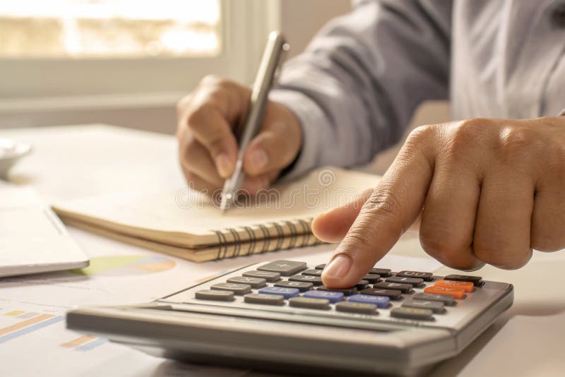 Close-up of Women Using Calculators and Note-taking, Accounting Reports ...