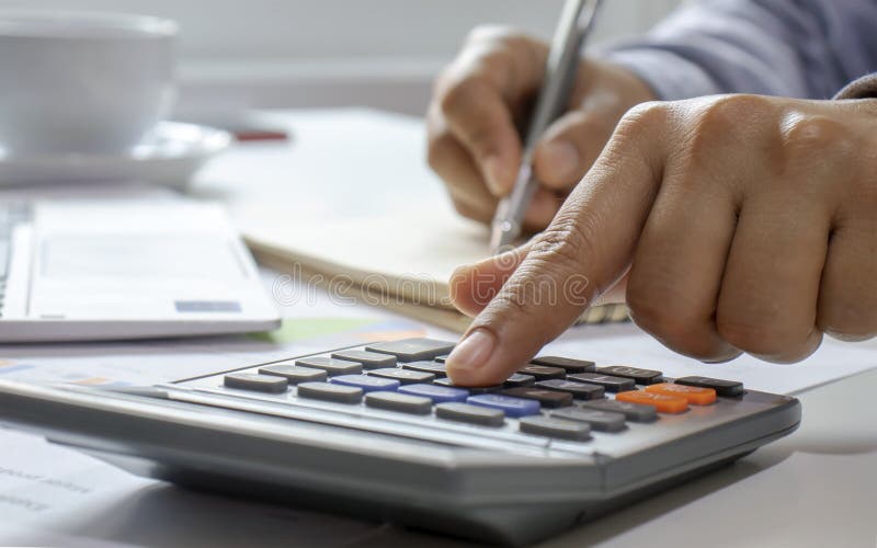 Close-up of Women Using Calculators and Note-taking, Accounting Reports ...