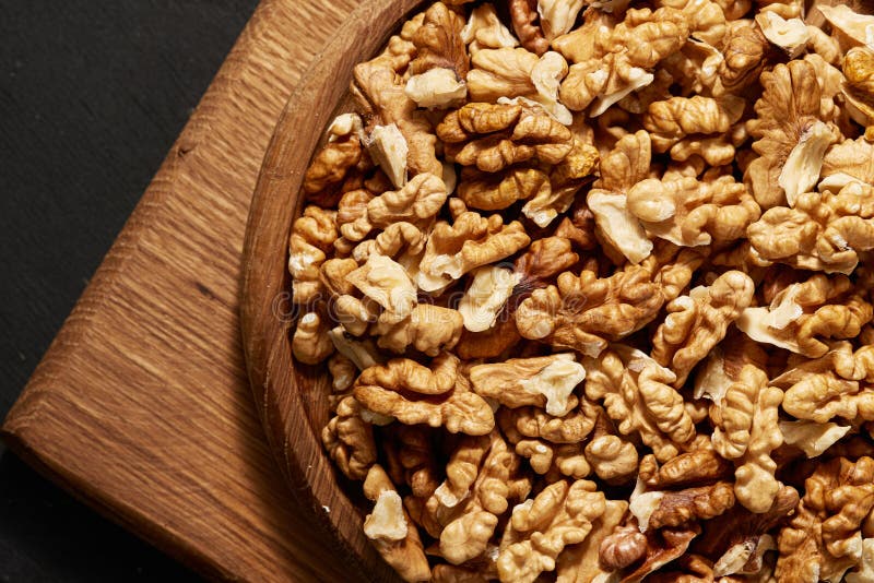 Close-up of a Wooden Plate of Peeled Walnut Kernels. Top View Stock ...