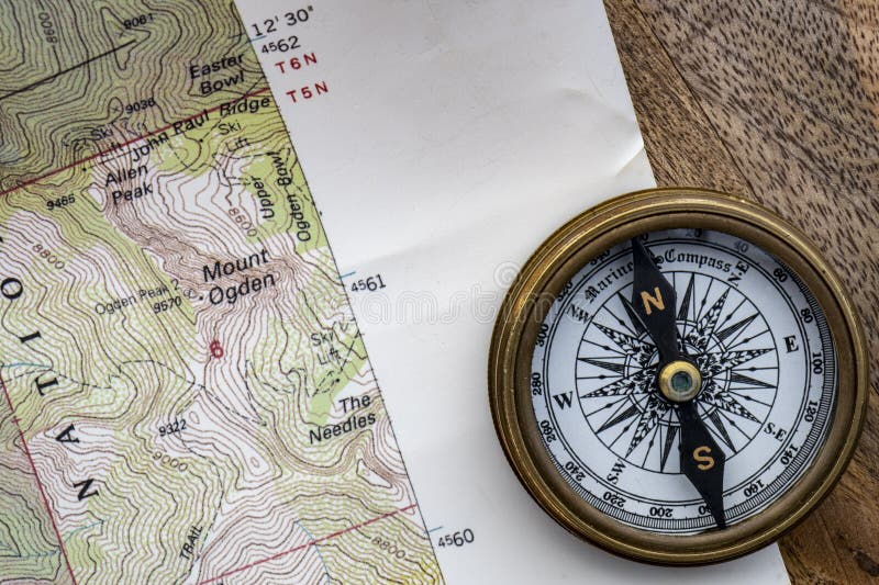 Close Up of Wooden Table with Topographical Map, Compass Placed on Top ...