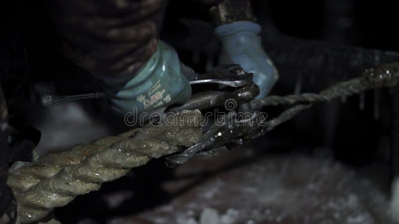 Close Up of Worker Fastening Rope with Metal Tool. Clip. Using Wrench ...