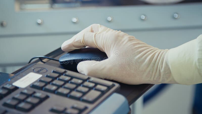 Close Up on a Worker Hand with Glove Working with a Computer Mouse ...
