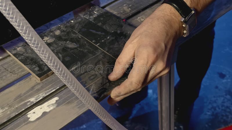 Close Up of a Worker Hands Moving Slowly a Ceramic Tile Covered by ...