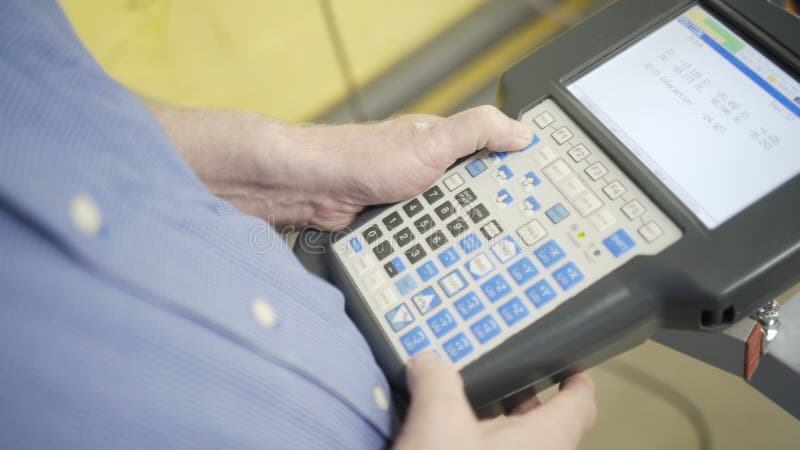 Close-up of Worker Holding Machine Control Panel in Factory. Action ...