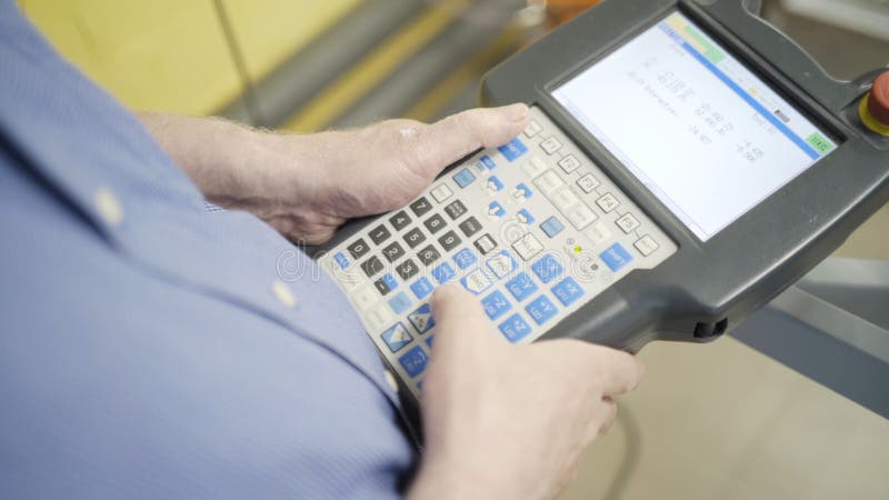 Close-up of Worker Holding Machine Control Panel in Factory. Action ...