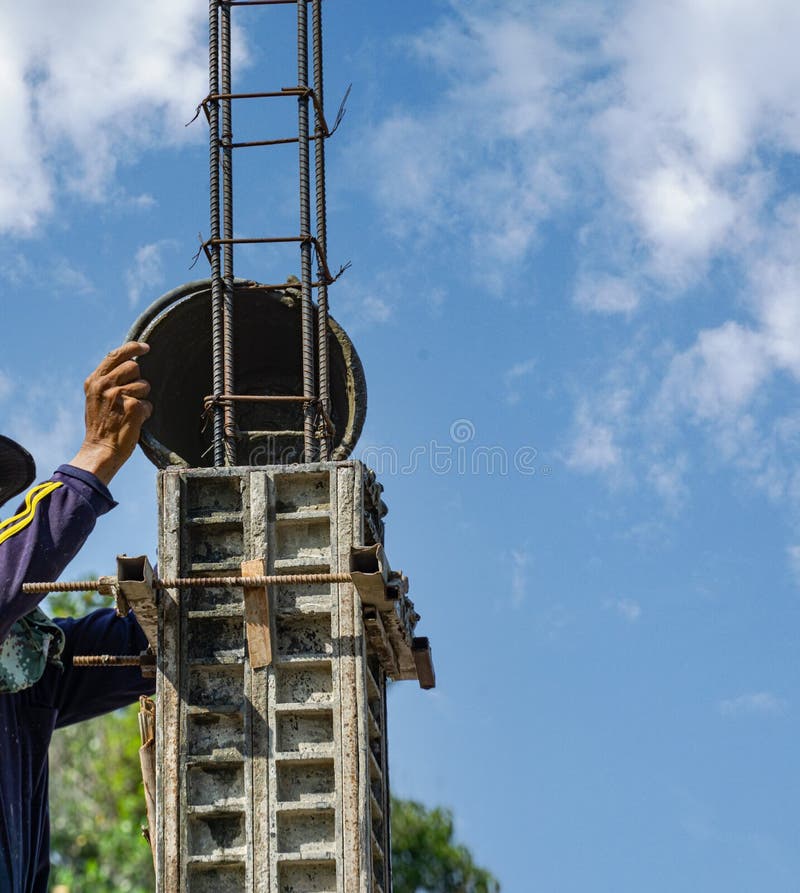 Close Up a Worker Hand Pours Cement To Form a Pillar. To Make a House ...