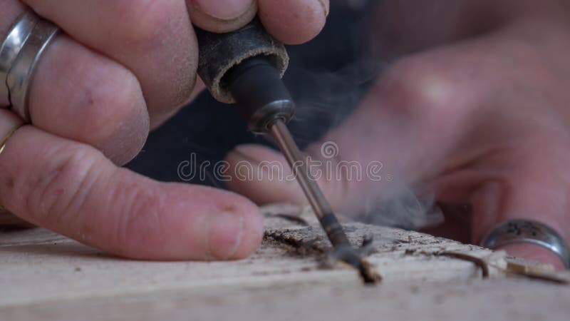 Close-up of Worker`s Hand with Tools Hacking Wood with Smoke that is ...