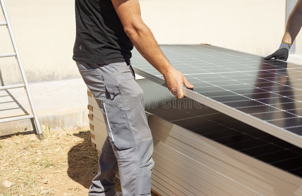 Close-up of a Worker S Hands Tying a Stack of Solar Panels with Orange ...